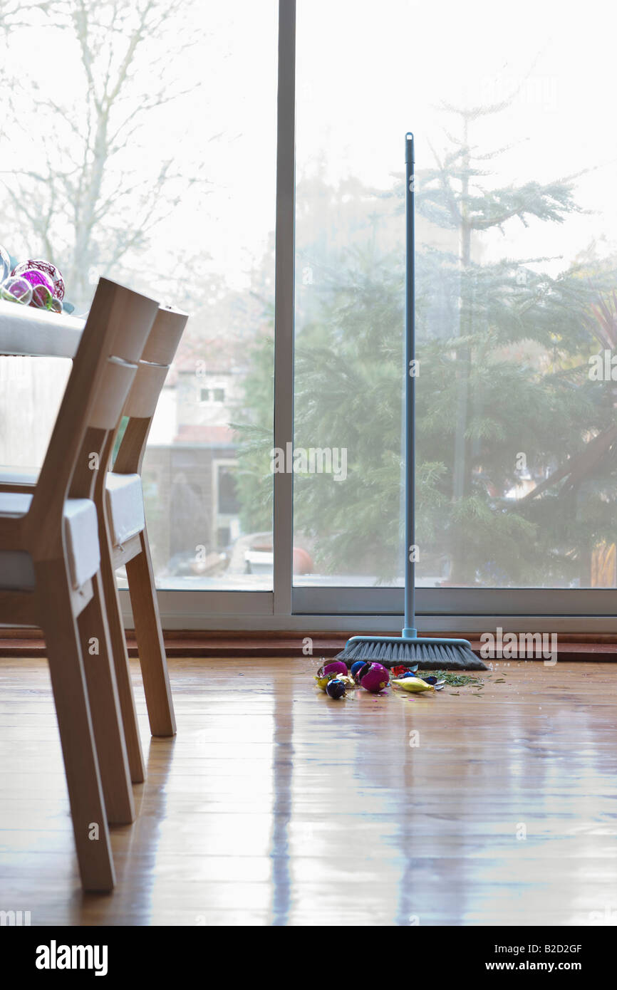Broom and small pile of broken Christmas decorations Stock Photo - Alamy