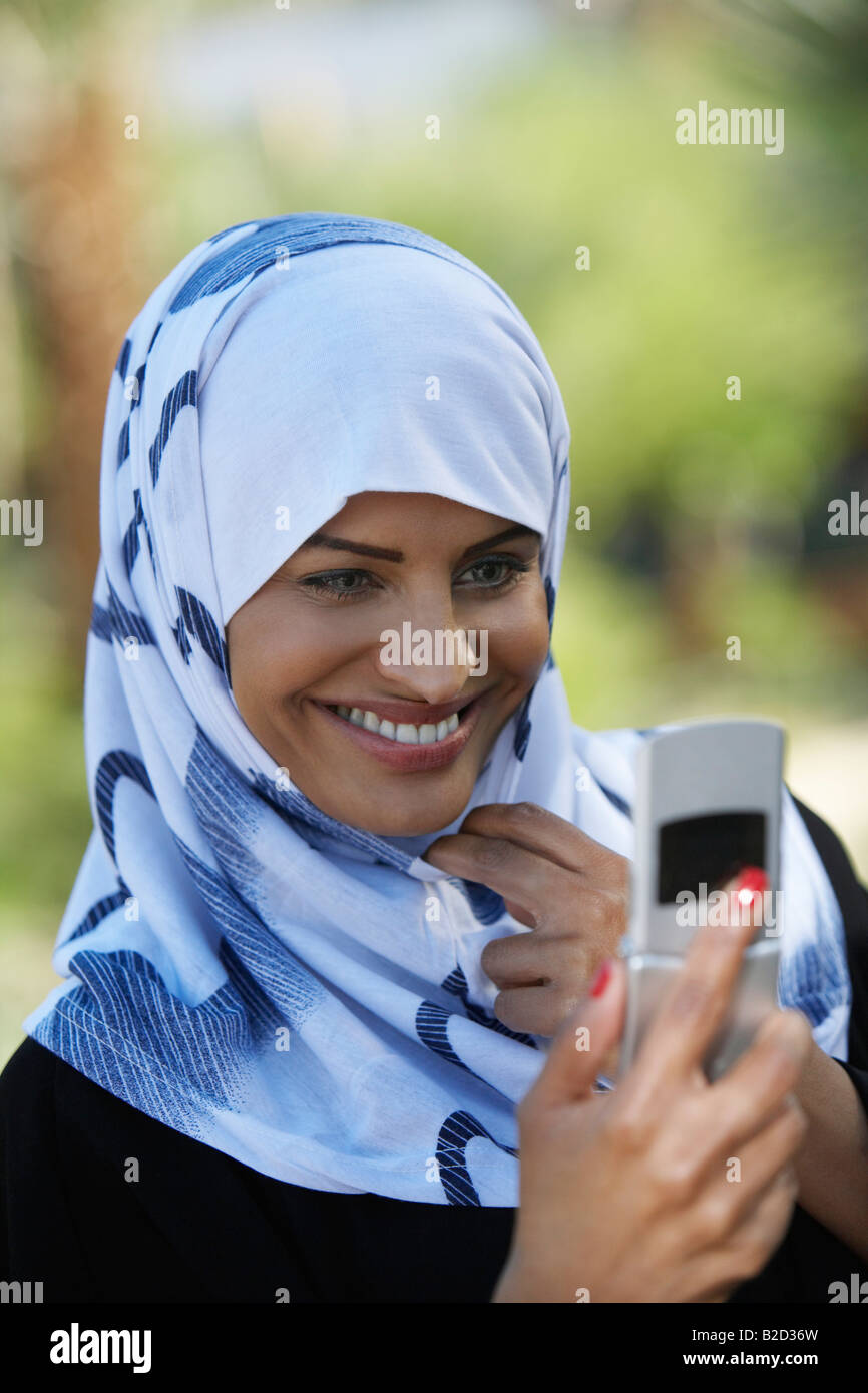 Muslim woman using mobile phone Stock Photo - Alamy