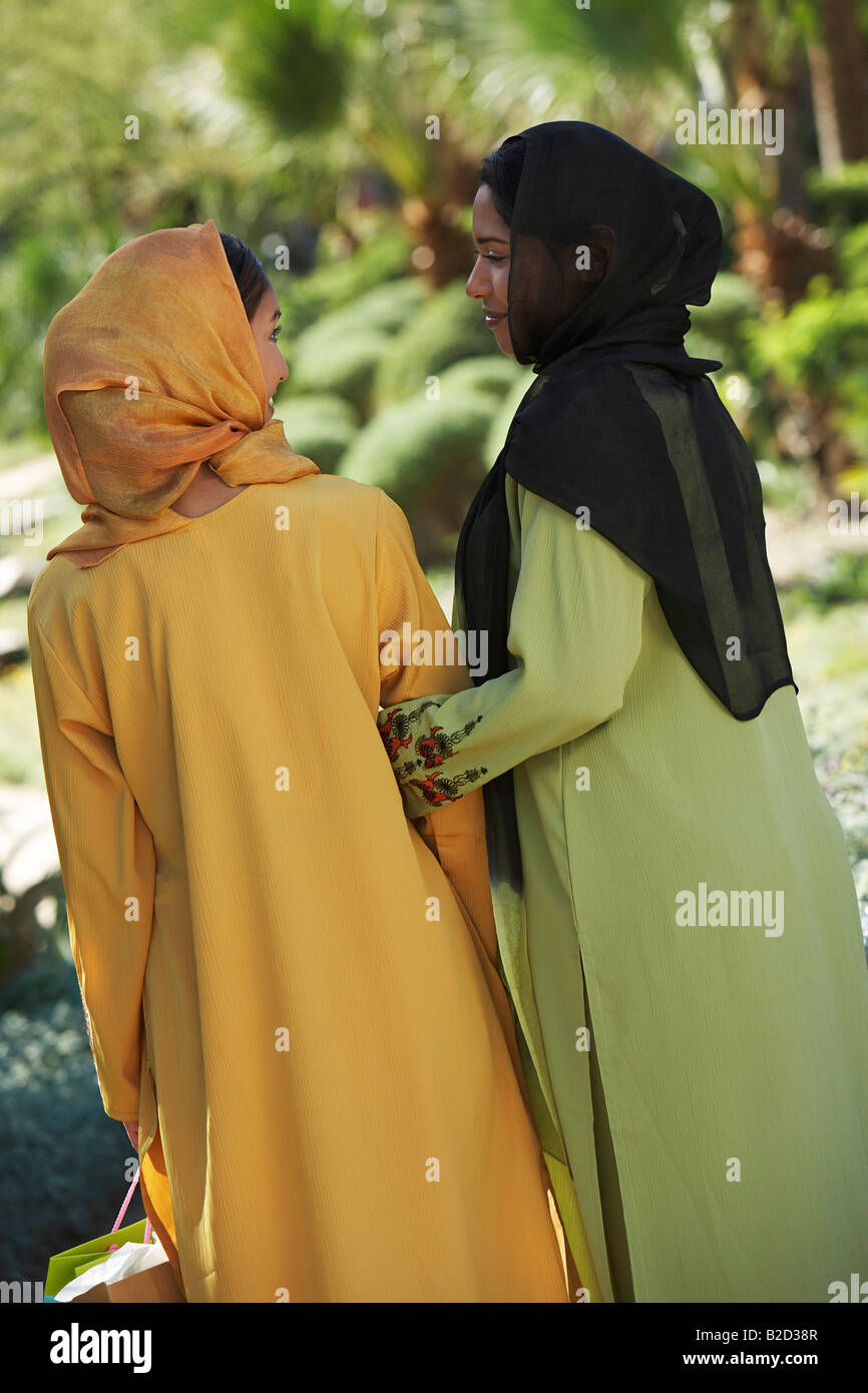 Two muslim woman in traditional clothing, back view Stock Photo - Alamy