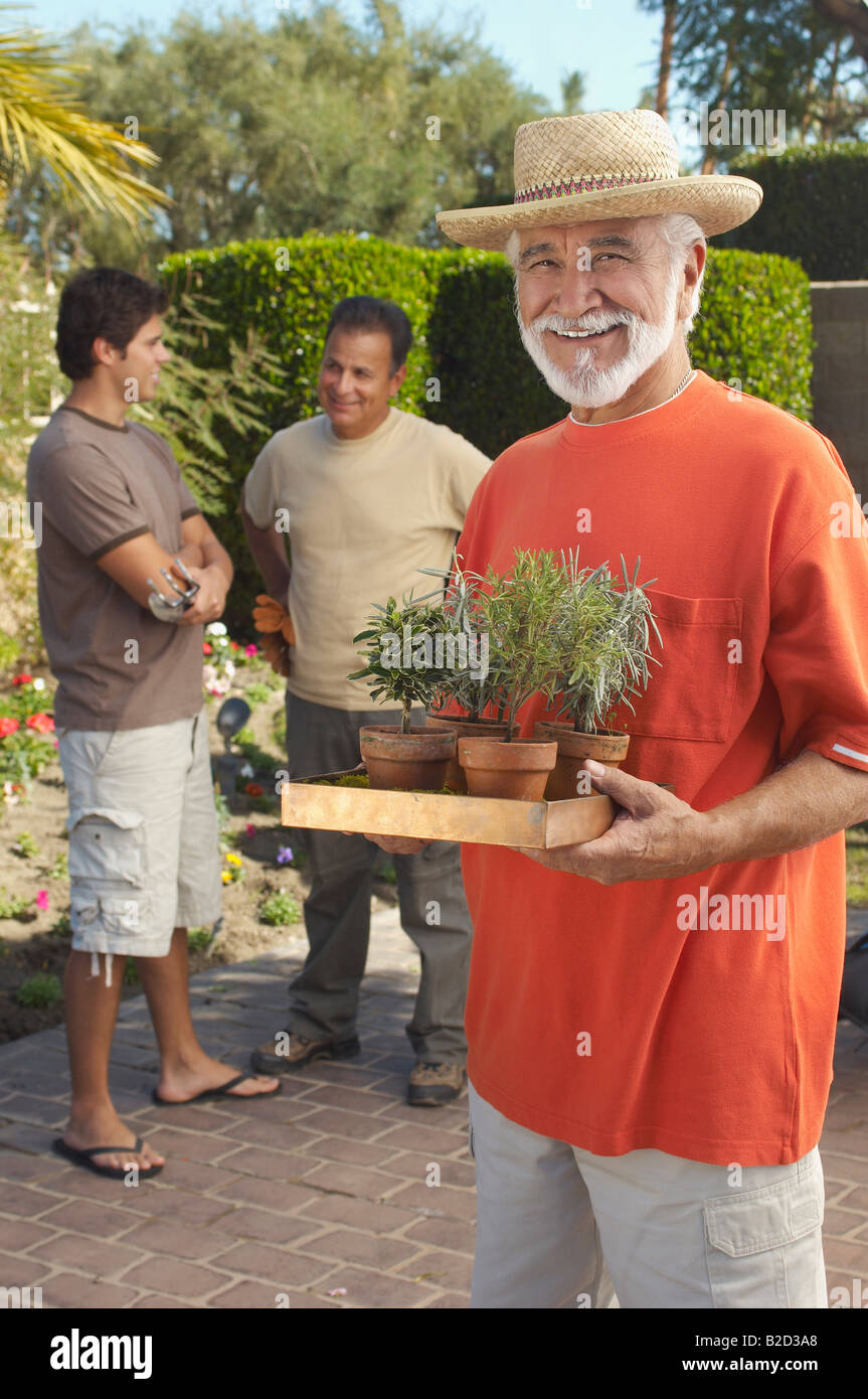 Portrait of man holding flowers in garden Stock Photo - Alamy