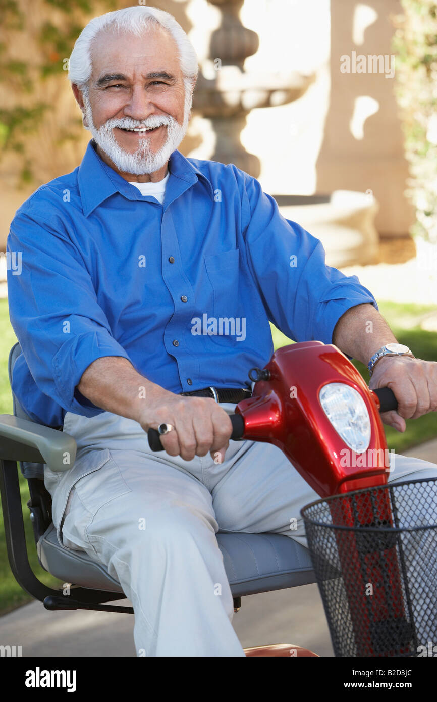 Elderly man on motor scooter Stock Photo - Alamy