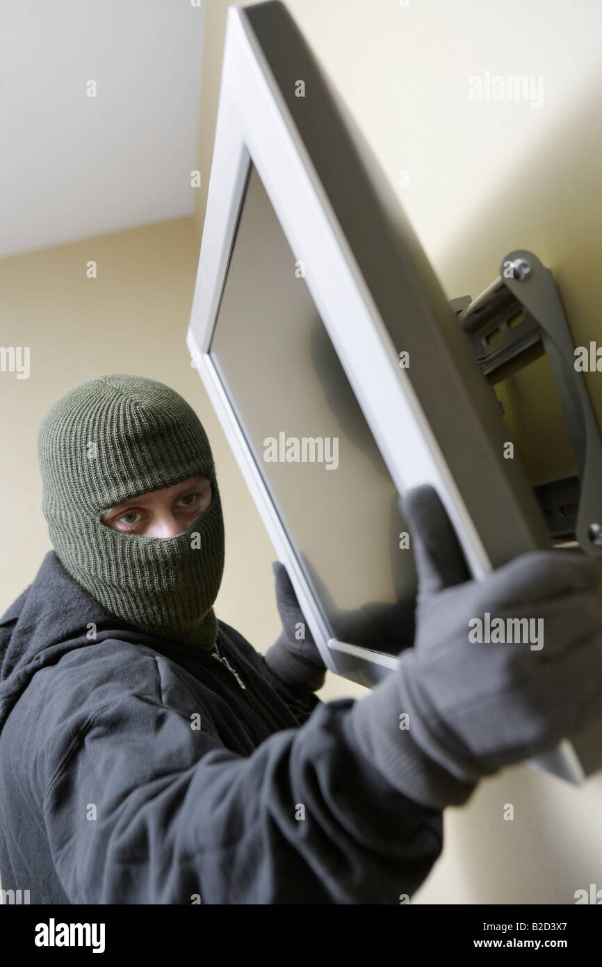Thief stealing flat screen television Stock Photo - Alamy