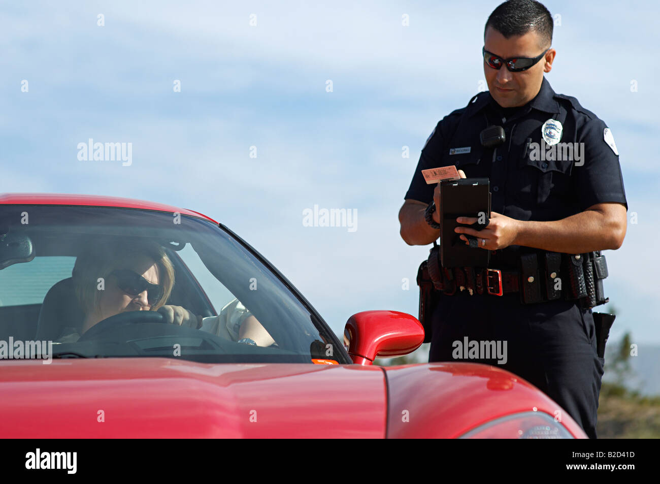 Traffic cop standing by sports car Stock Photo - Alamy
