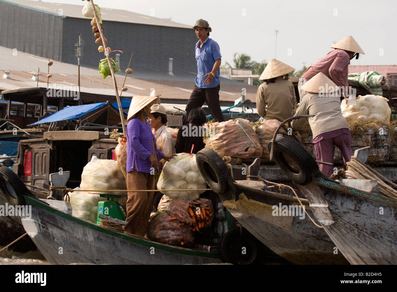 Boats participate in the Cai Be floating market, held in the Mekong ...