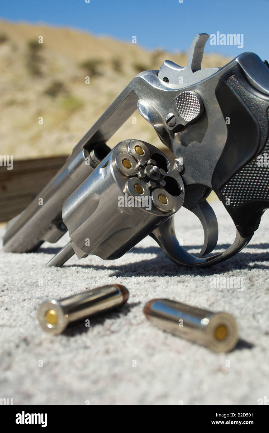 Bullets beside gun, close-up Stock Photo - Alamy