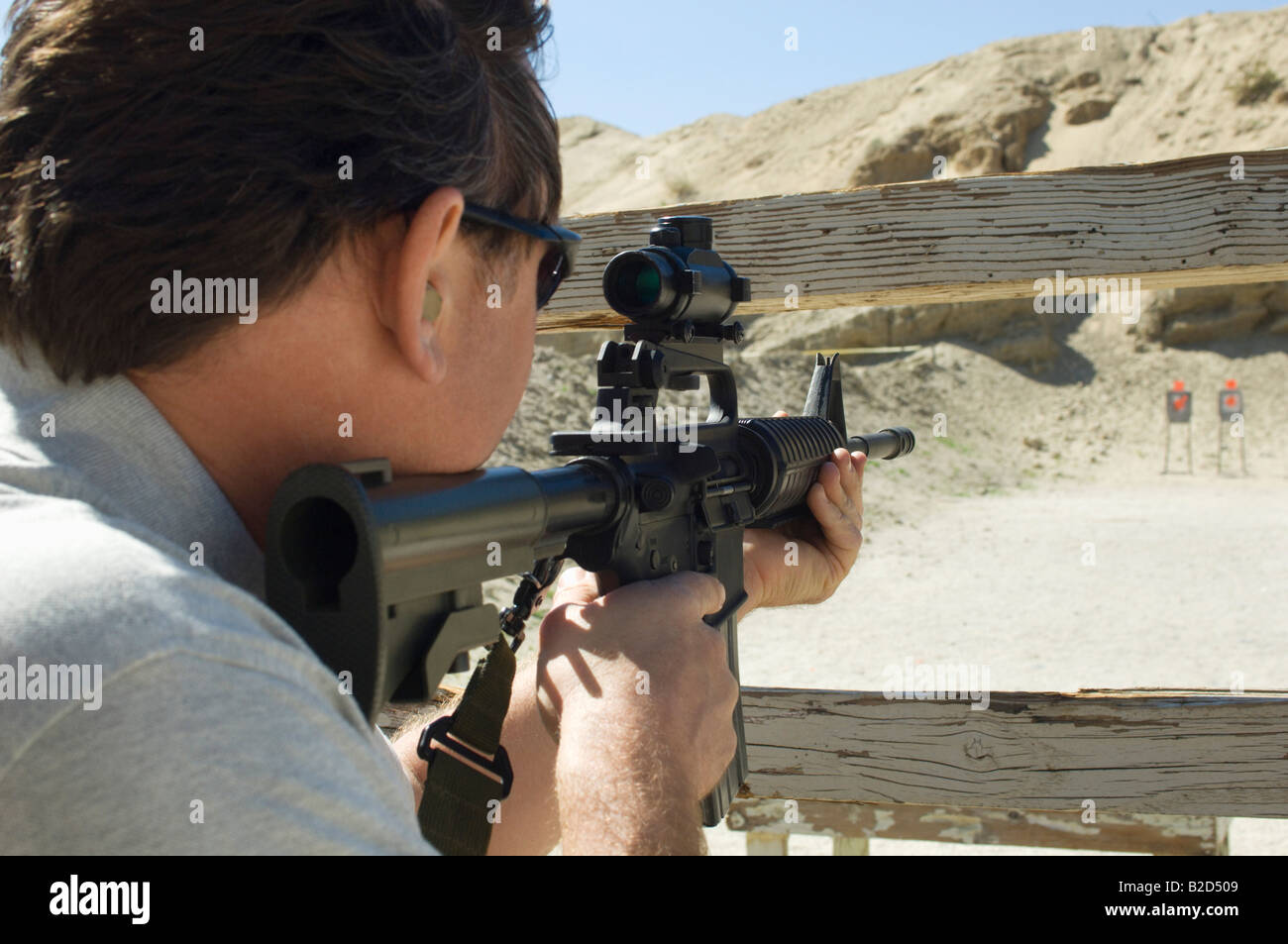 Man aiming rifle at firing range Stock Photo - Alamy