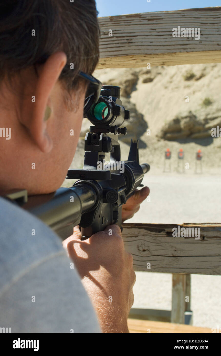 Man aiming rifle at firing range Stock Photo - Alamy