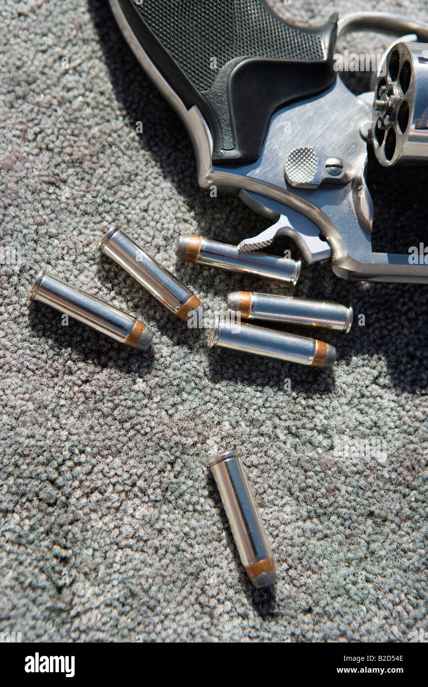 Hand gun and bullets on carpet Stock Photo - Alamy