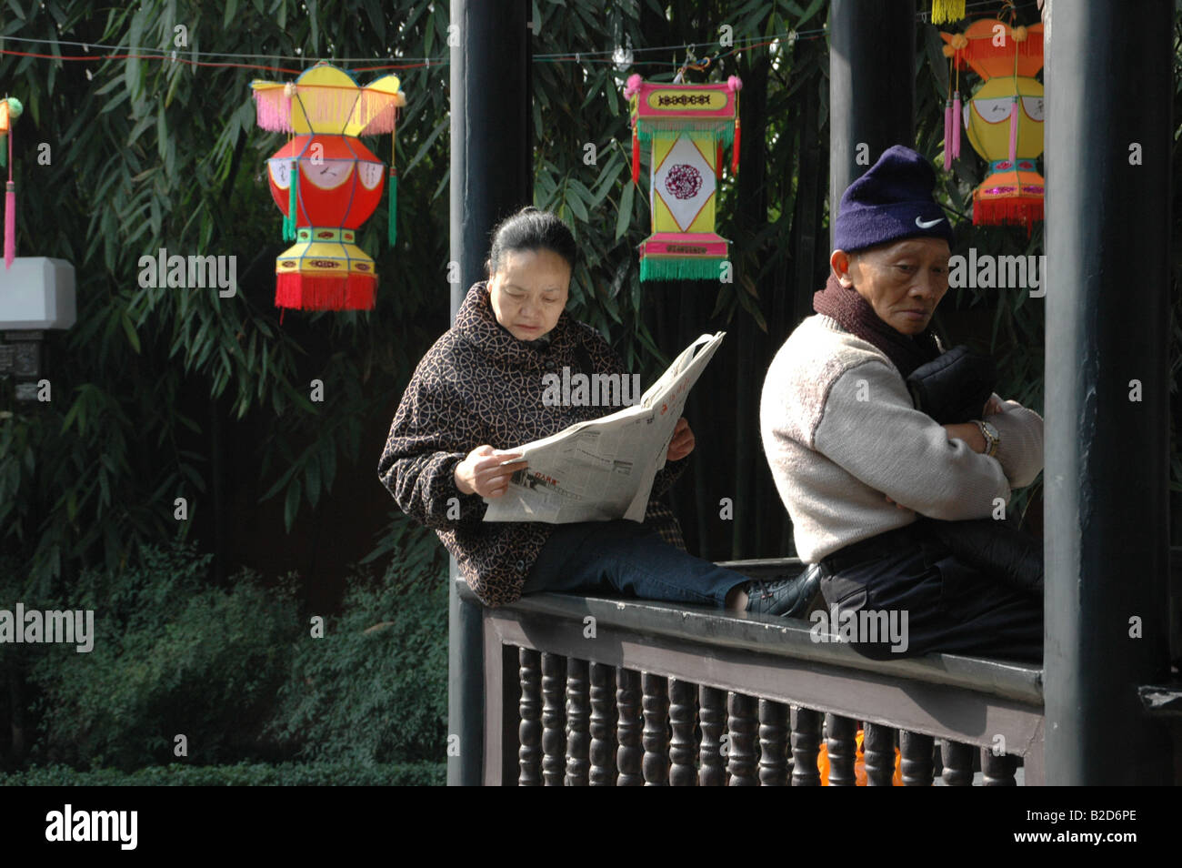 chinese woman reading newspaper near temple Stock Photo - Alamy