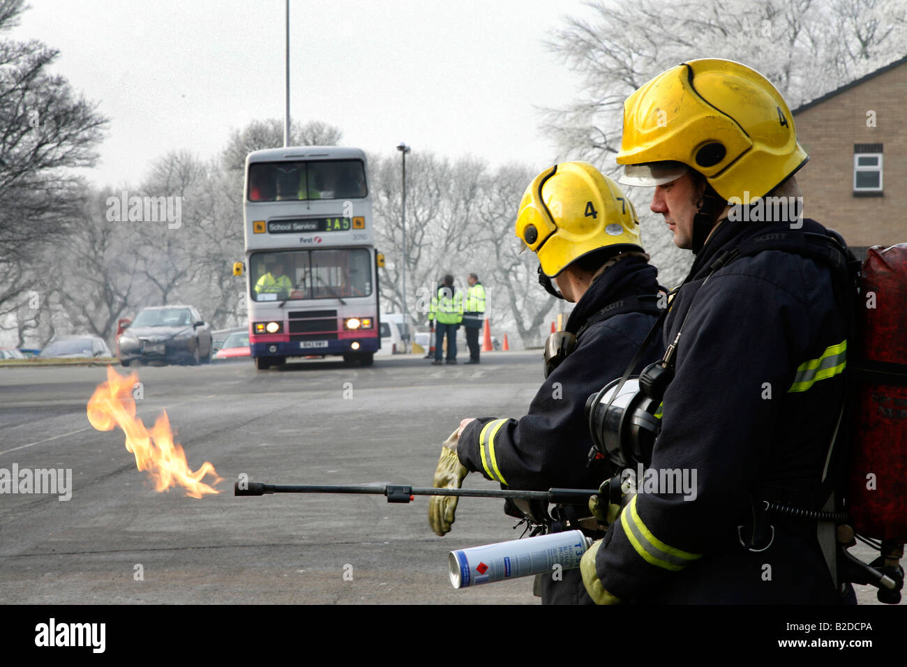Firemen about to torch a bus for a demonstration Stock Photo - Alamy