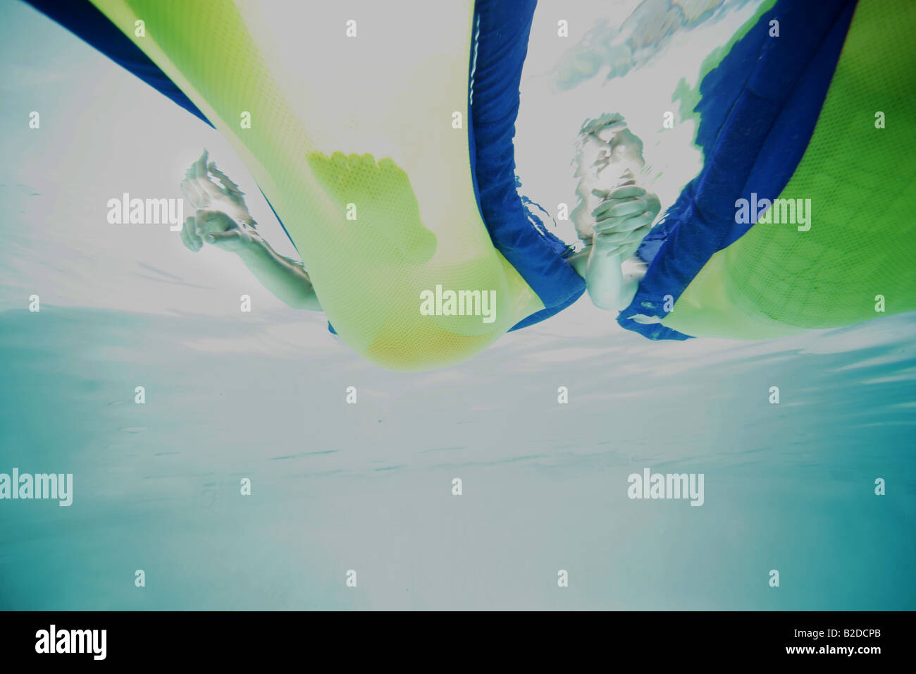 Underwater view of couple floating on rafts Stock Photo - Alamy