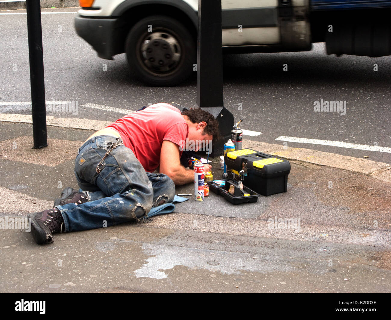 Street Artist Painting onto Discarded Chewing Gum on Pavement Stock ...