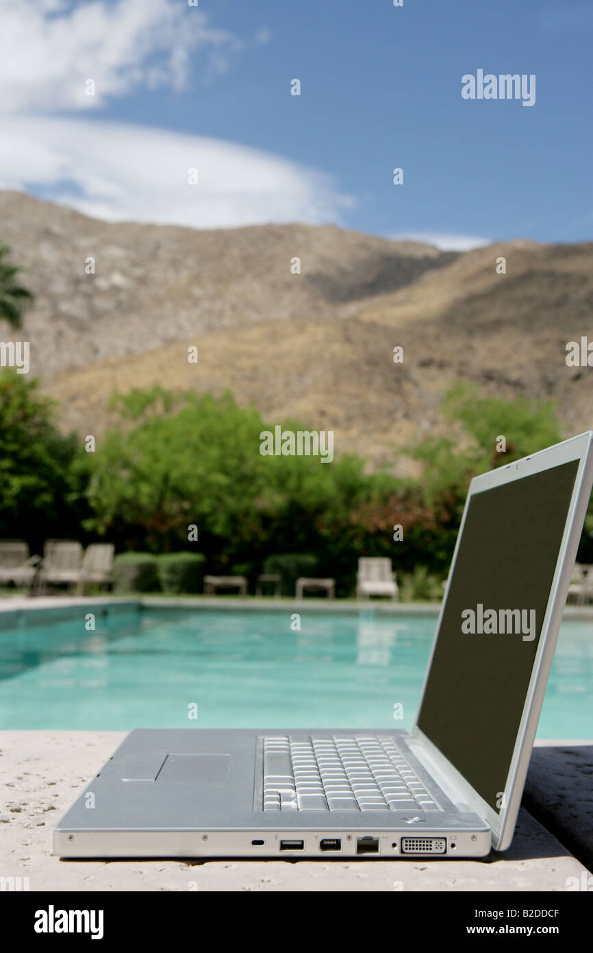 Laptop computer near swimming pool Stock Photo - Alamy