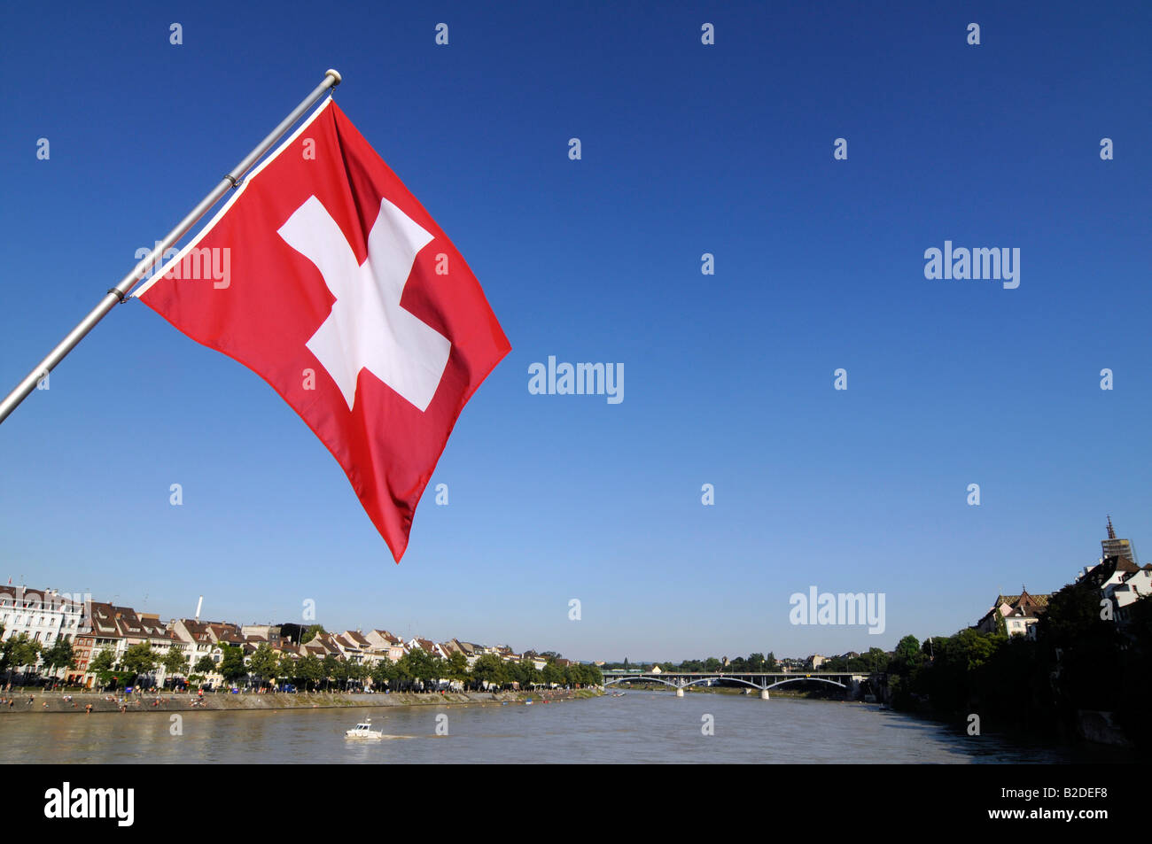 The Swiss flag flying on Basel's oldest bridge, with a view on the ...