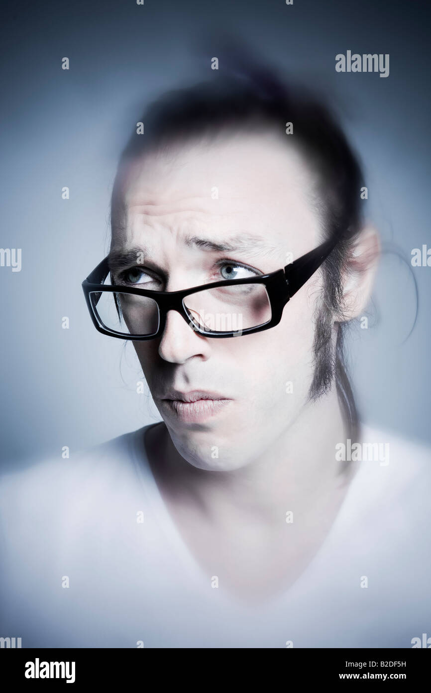 studio shot portrait of young expressive man making faces Stock Photo ...