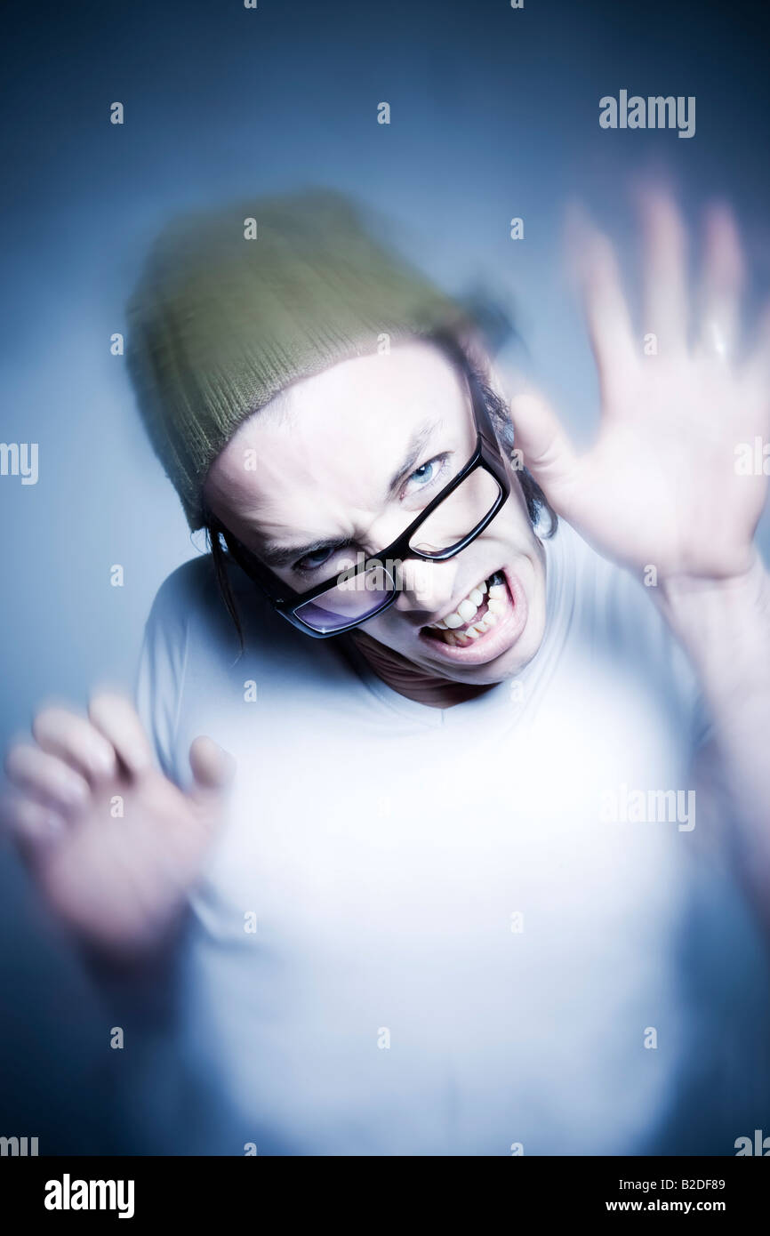 studio shot portrait of young expressive man making faces Stock Photo ...