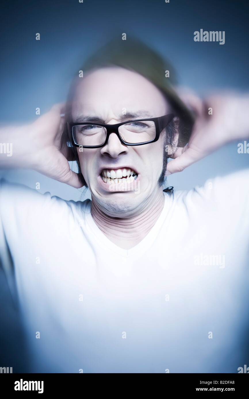 studio shot portrait of young expressive man making faces Stock Photo ...