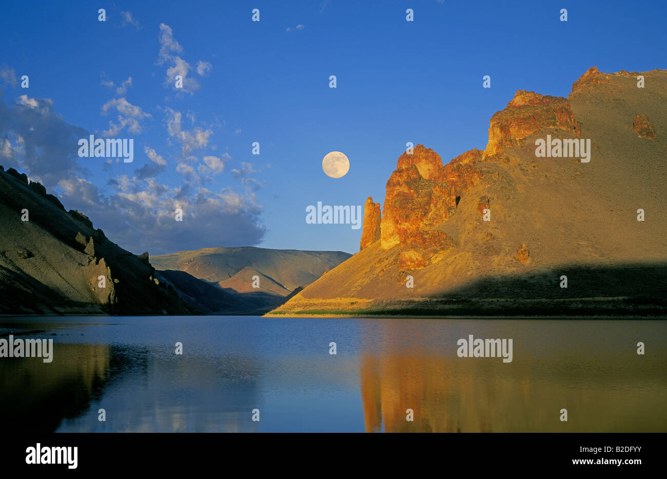A full moon sets over Owyhee Reservoir on the Owyhee River along the ...
