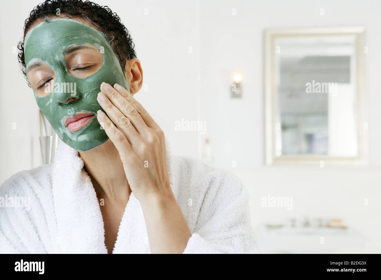 African American woman touching facial mask Stock Photo - Alamy