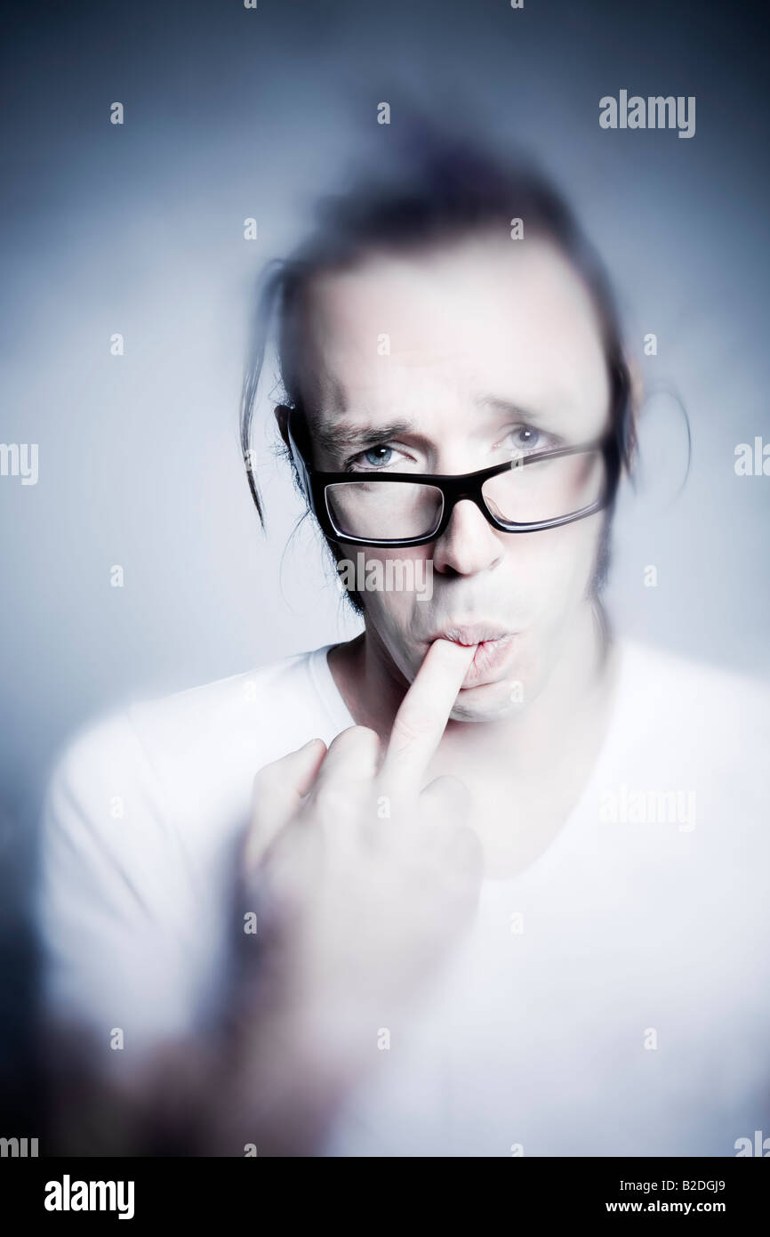 studio shot portrait of young expressive man making faces Stock Photo ...