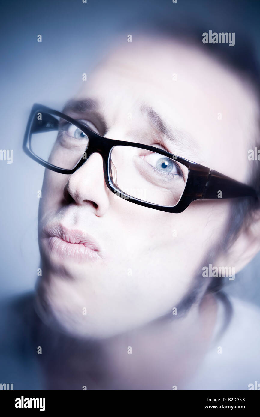 studio shot portrait of young expressive man making faces Stock Photo ...