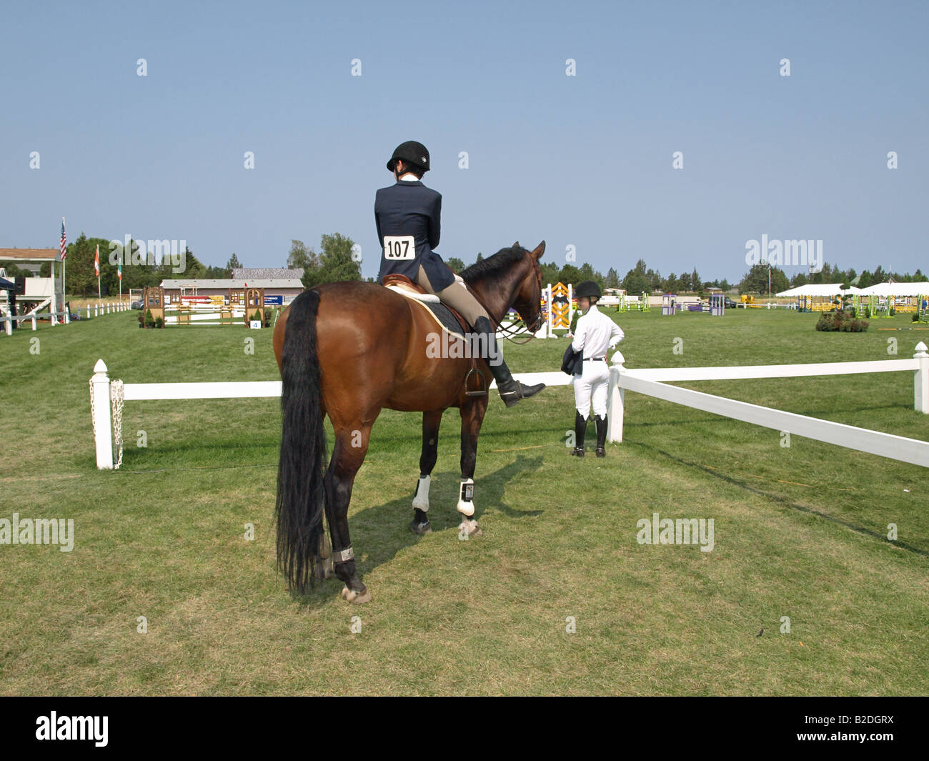 A young rider waits her turn to enter the ring at a Hunter Jumper ...