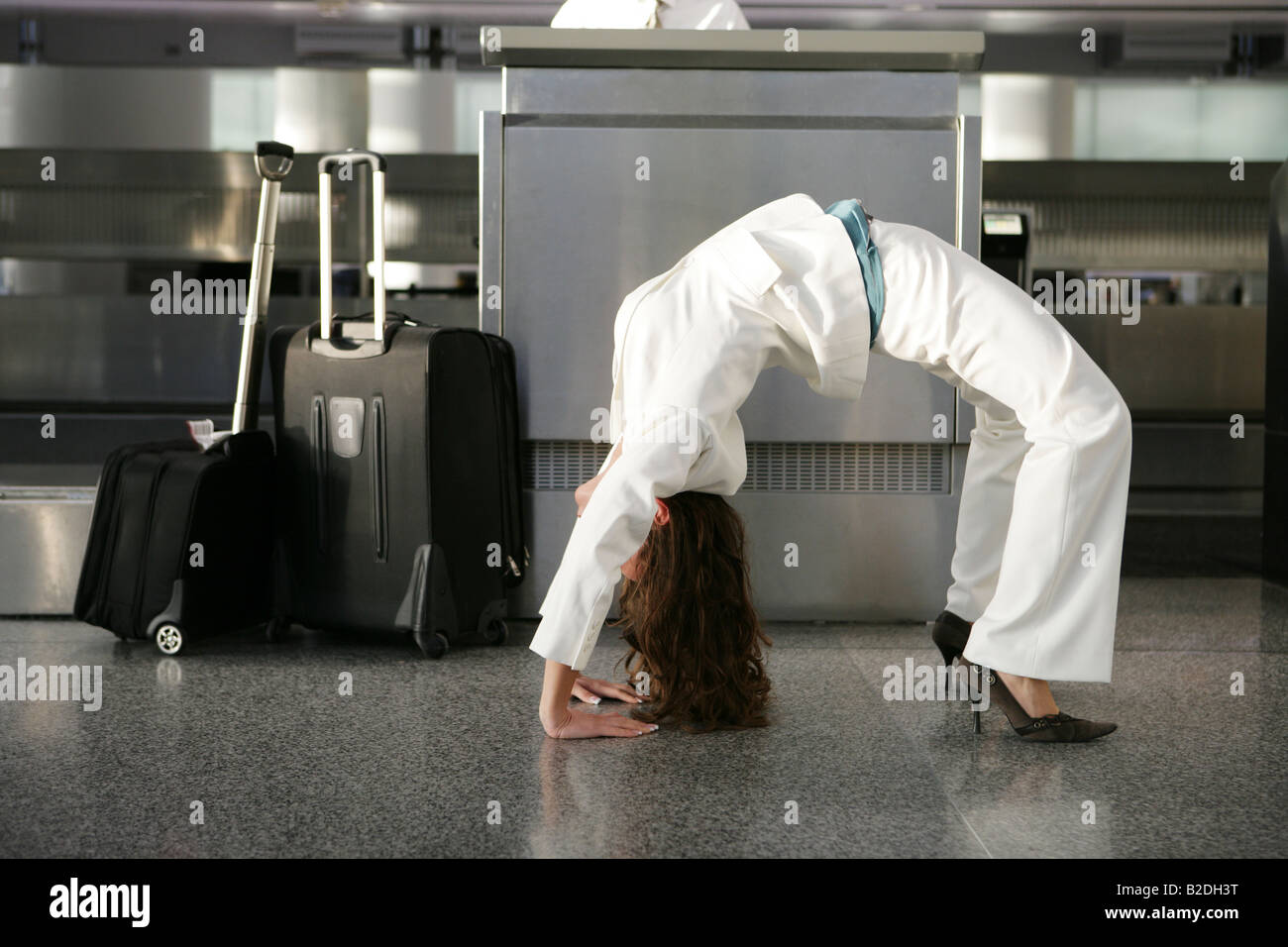 Young businesswoman doing back flip in airport Stock Photo - Alamy