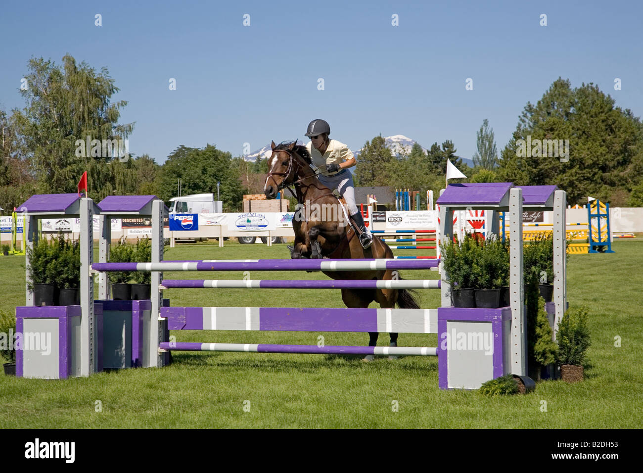 A rider takes a jump in the hunter jumper ring during an equestrian ...