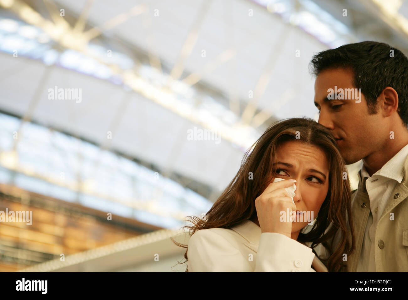 Sad couple in airport saying goodbye Stock Photo - Alamy