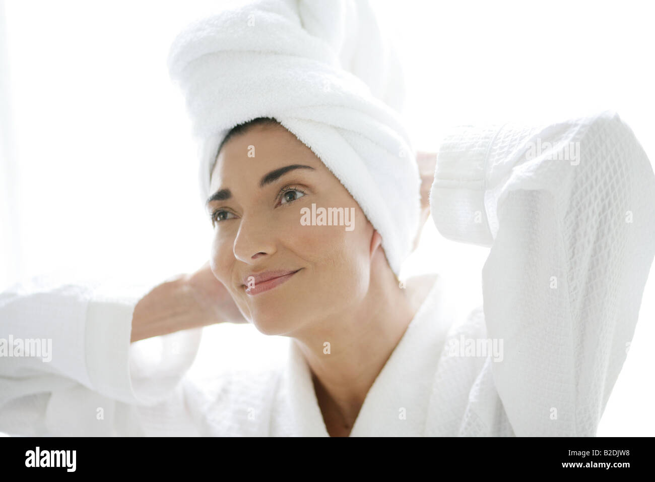 Happy woman with towel on head Stock Photo - Alamy