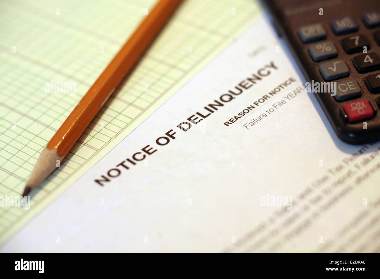 Notice of Deliquency Paperwork with Calculator and Graph Paper Stock ...