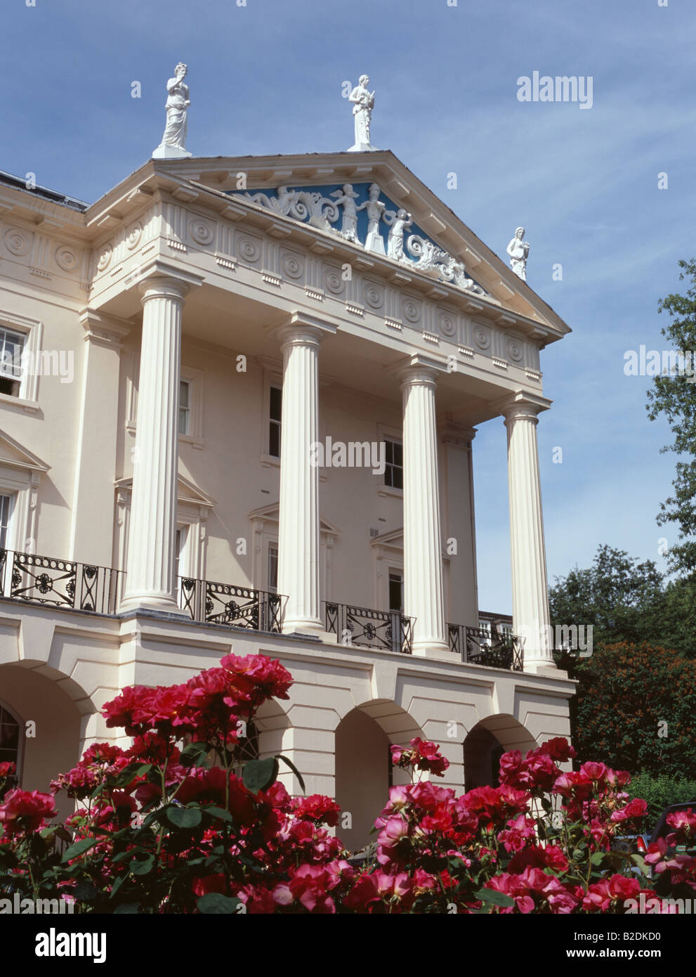 Classical statues and ornate plasterwork on pediment of large Regency ...
