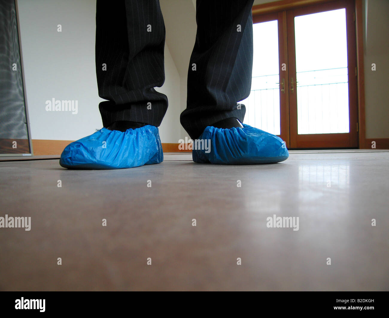 Businessmans feet with protective overshoes Stock Photo - Alamy
