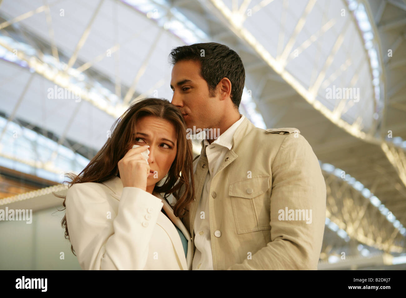 Sad couple in airport saying goodbye Stock Photo - Alamy