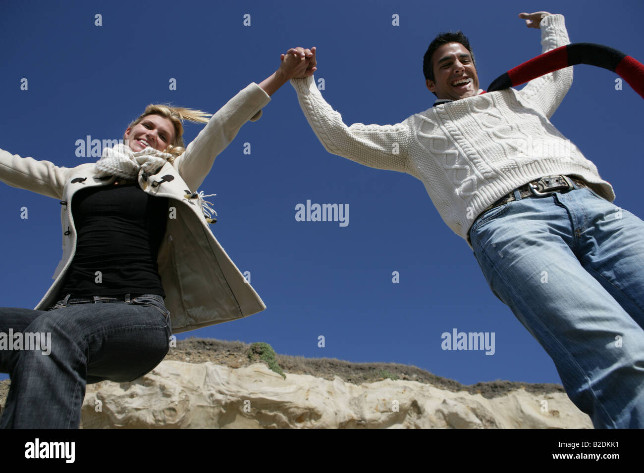 Happy couple jumping in air Stock Photo - Alamy