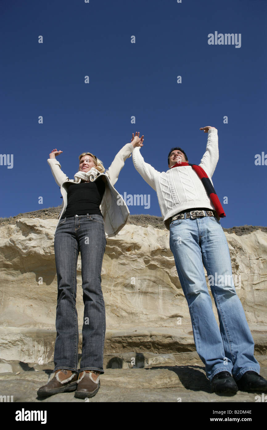 Couple jumping off cliff holding hi-res stock photography and images ...