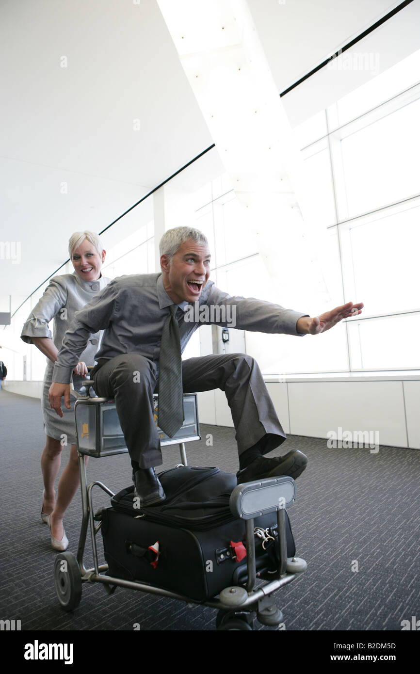 Mature couple having fun in airport Stock Photo - Alamy