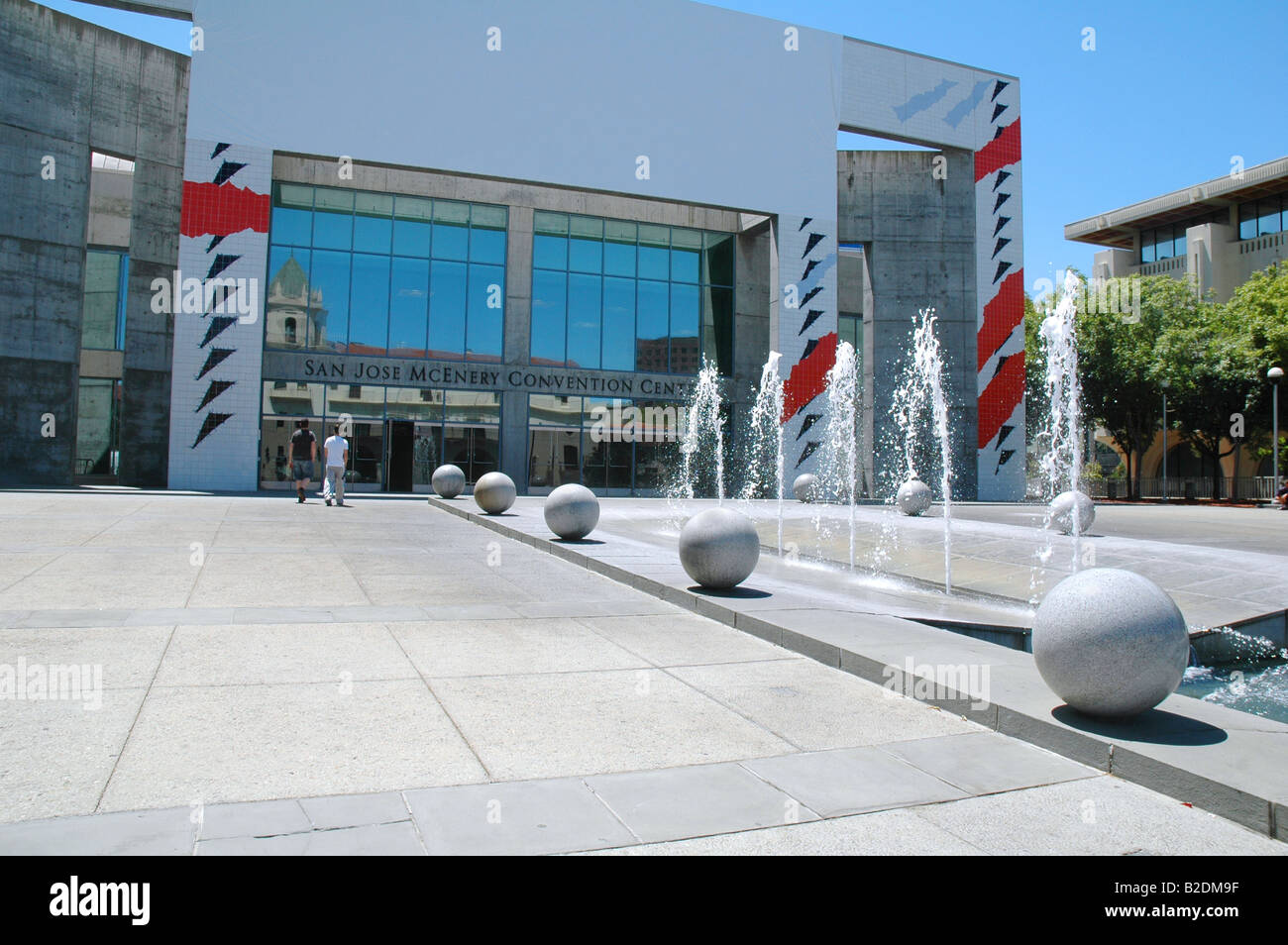 two people walking towards main entrance {"san jose" mcenery convention ...