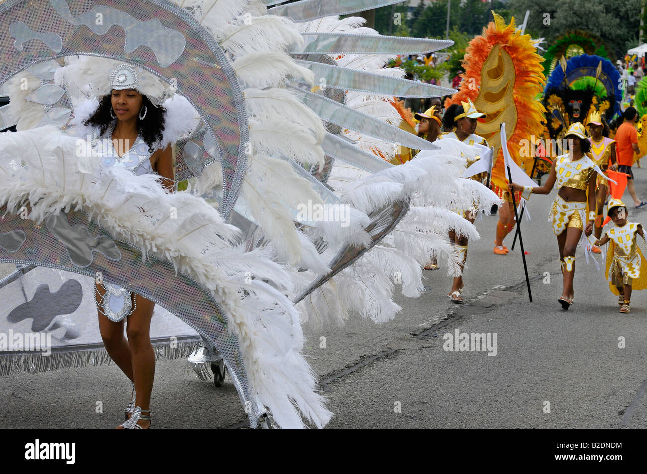 Beautiful black girl playing white Queen in float costume leads the ...