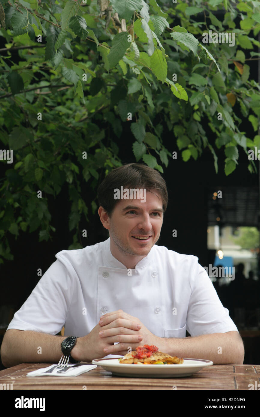 Male chef sitting at outdoor café Stock Photo - Alamy