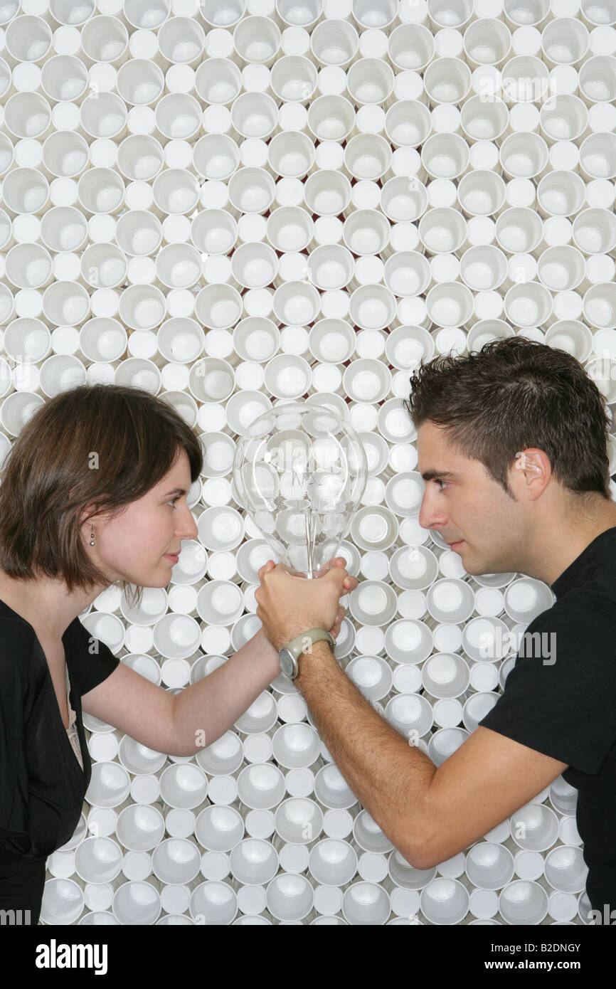 Couple holding large lightbulb Stock Photo - Alamy