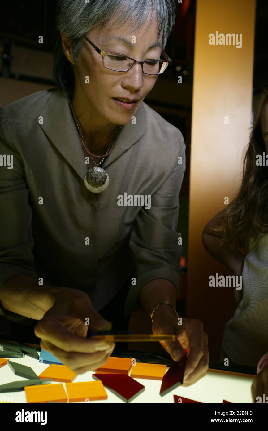 Art teacher helping students in art class Stock Photo - Alamy