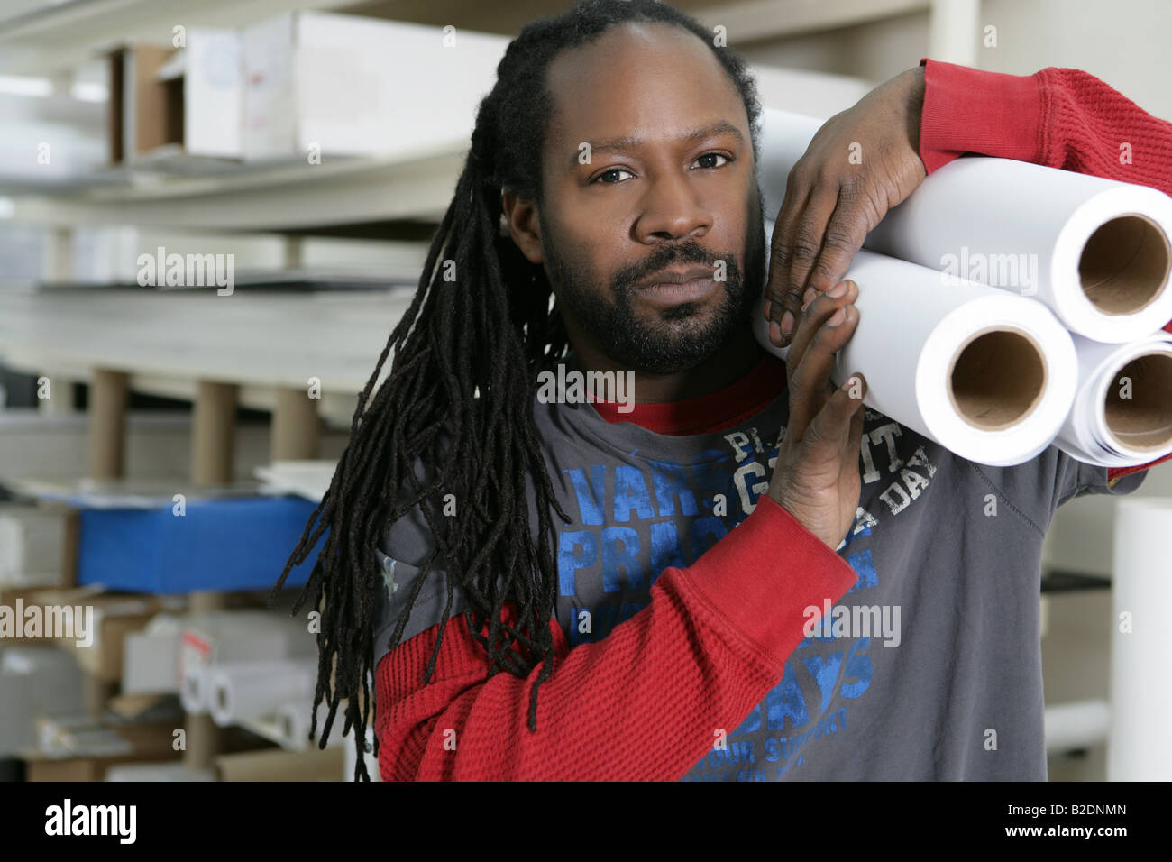 African American man holding rolls of paper Stock Photo - Alamy