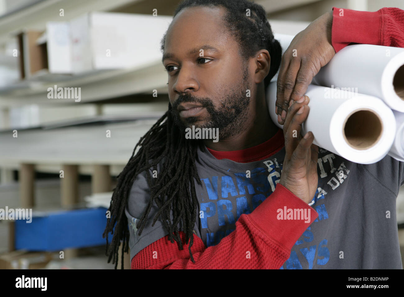 African American man holding rolls of paper Stock Photo - Alamy
