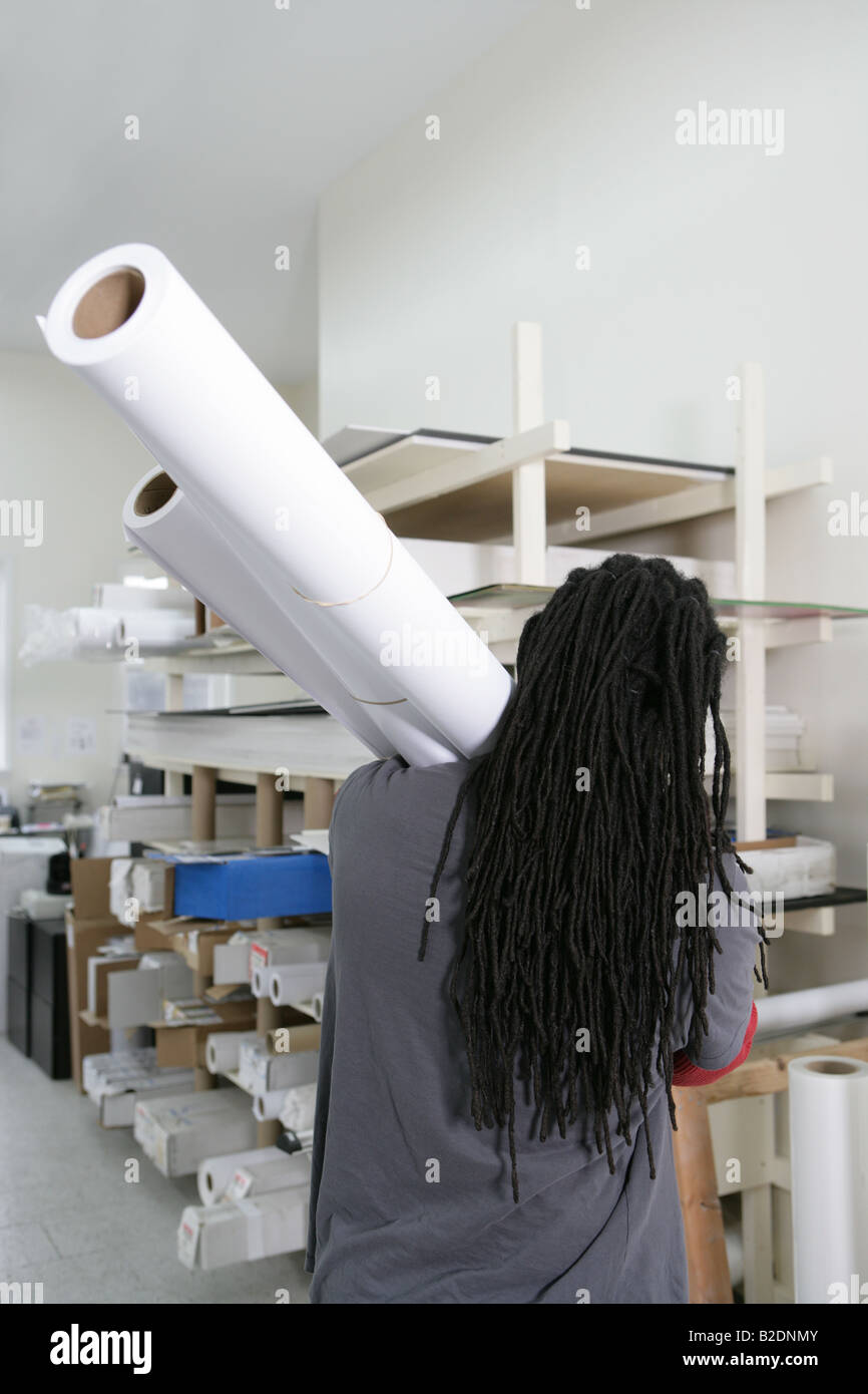 African American man holding rolls of paper Stock Photo - Alamy