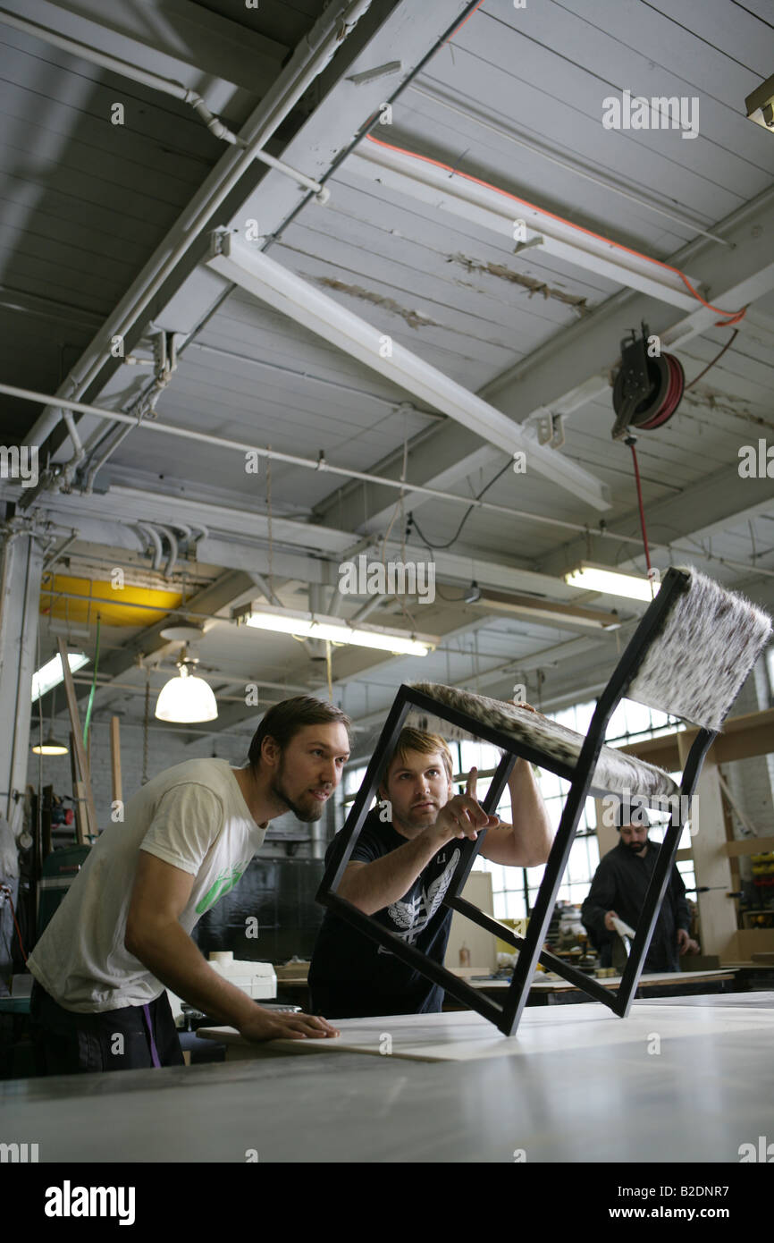 Men inspecting chair in warehouse Stock Photo - Alamy