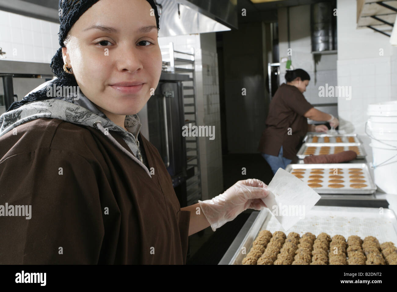 Portrait of female worker in kitchen Stock Photo - Alamy