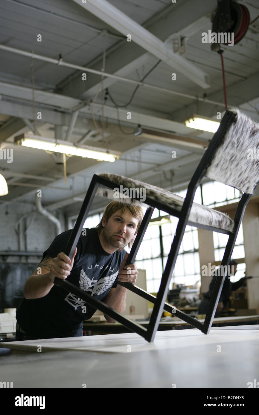 Man inspecting chair in warehouse Stock Photo - Alamy