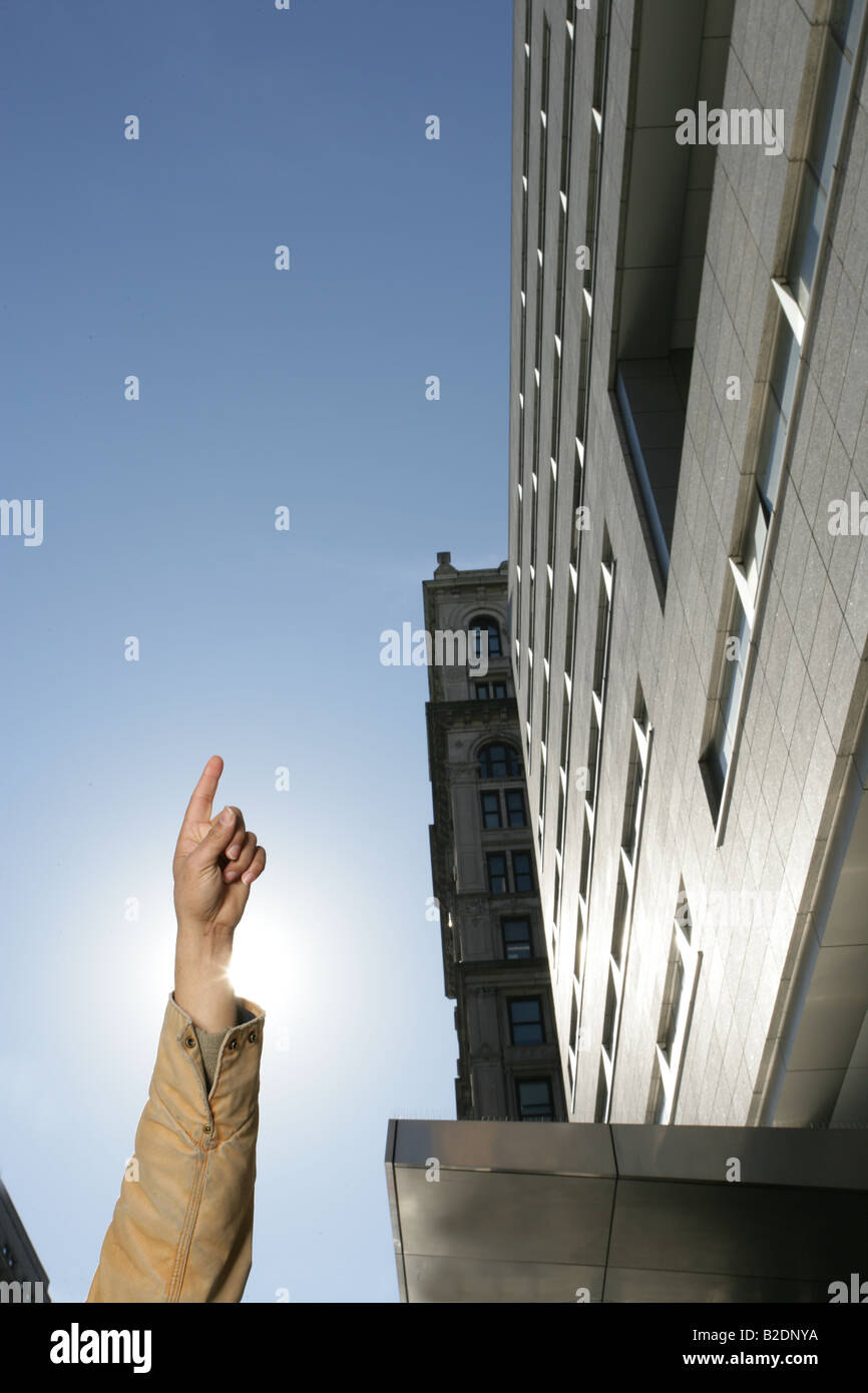 Construction worker pointing to building Stock Photo - Alamy