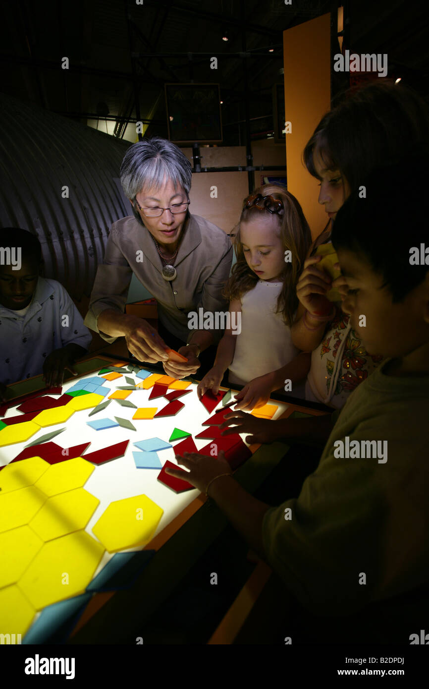 Art teacher helping students in art class Stock Photo - Alamy